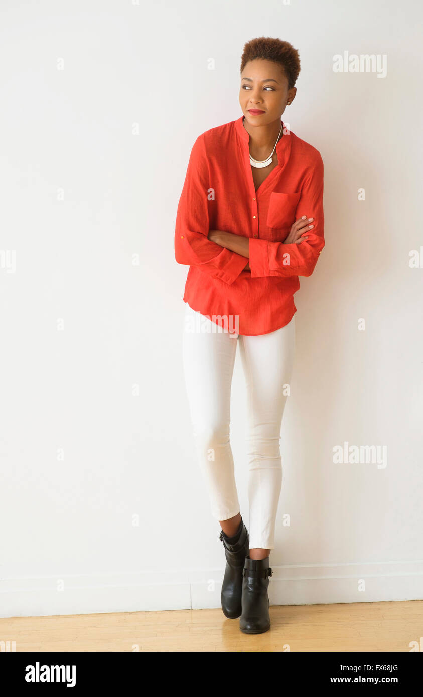 Mixed race woman standing with arms crossed Stock Photo - Alamy