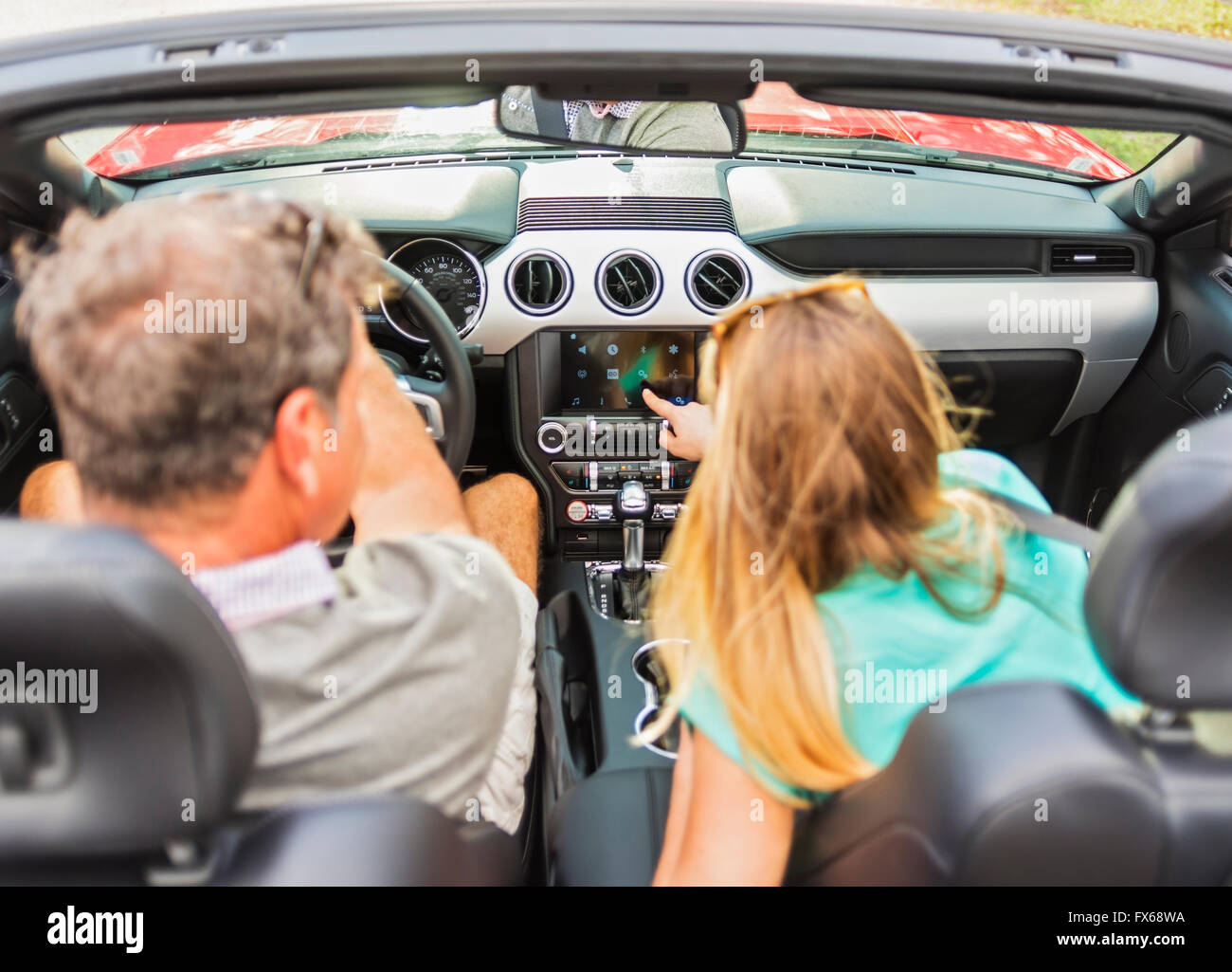 Caucasian couple driving convertible Stock Photo - Alamy