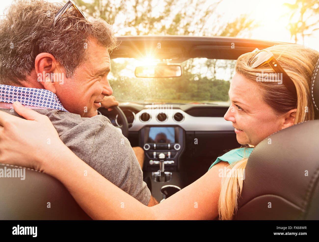 Caucasian couple driving convertible Stock Photo - Alamy