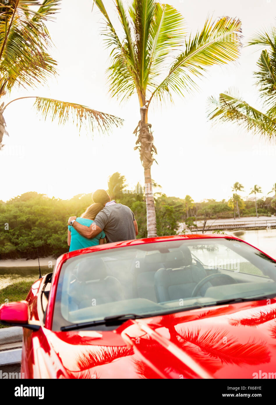 Caucasian couple hugging on convertible Stock Photo - Alamy