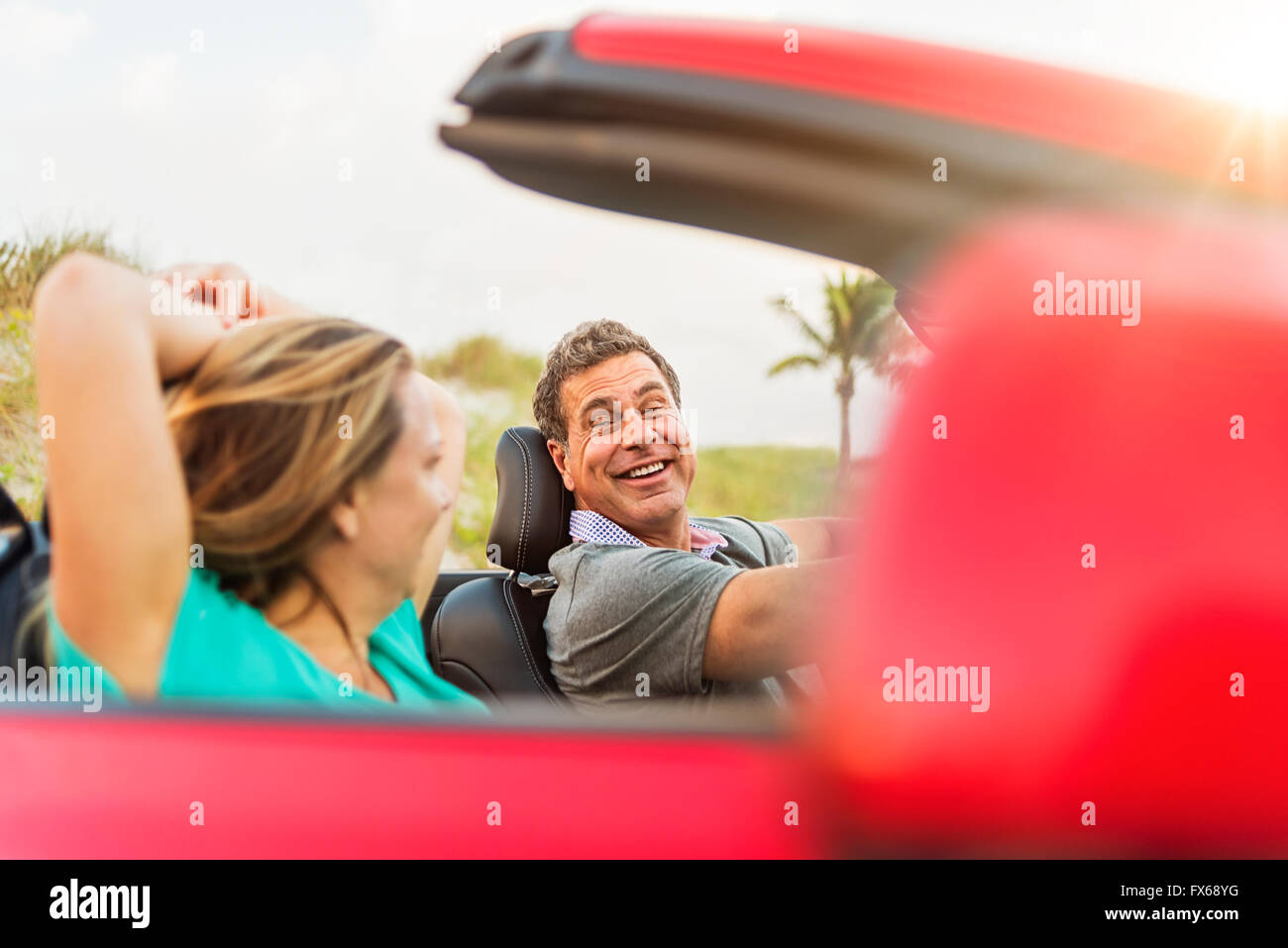 Caucasian couple driving in convertible Stock Photo - Alamy