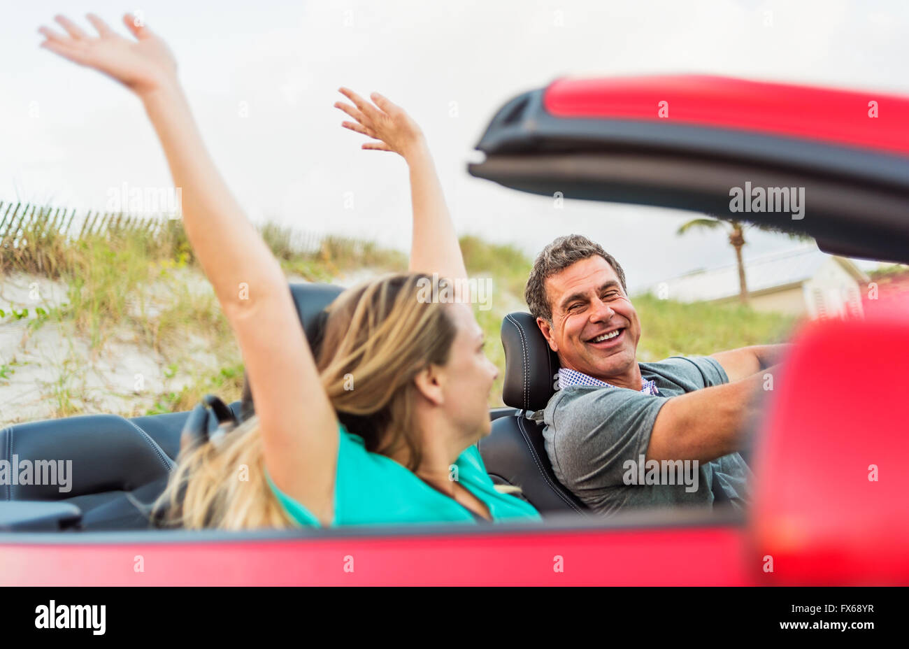 Caucasian couple driving in convertible Stock Photo - Alamy