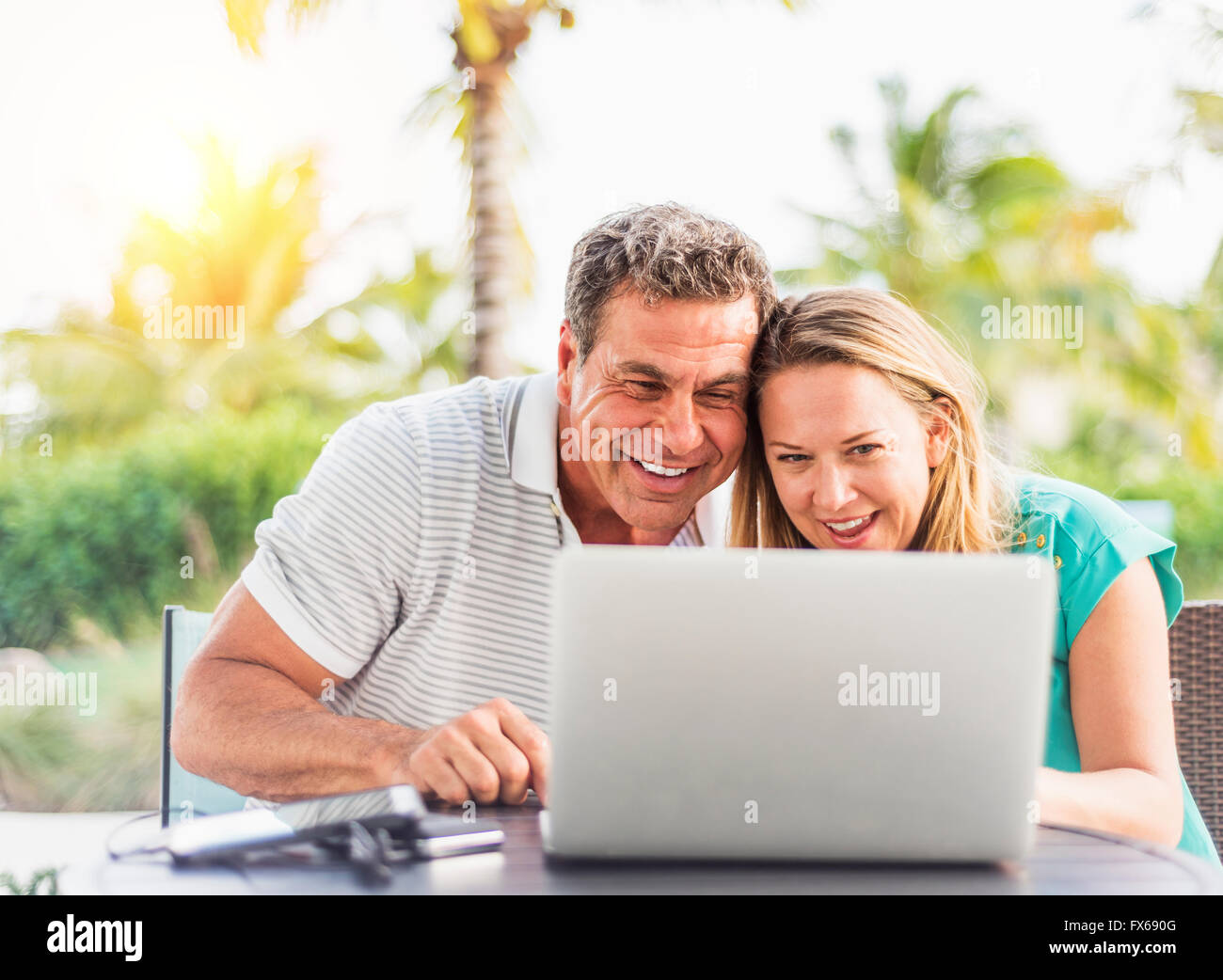 Caucasian couple using laptop outdoors Stock Photo - Alamy