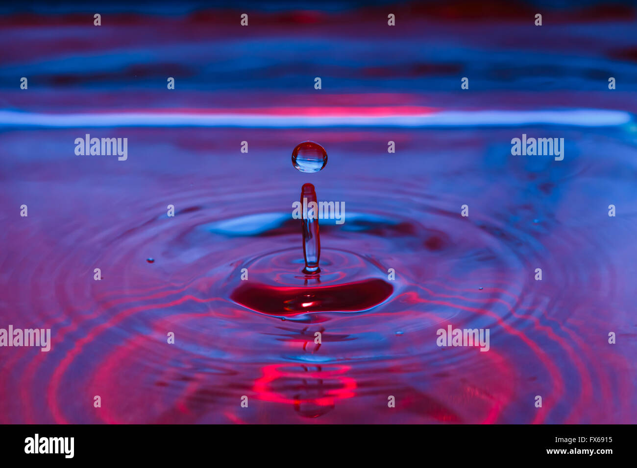 Beautiful colorful water splash from fallen drop Stock Photo - Alamy