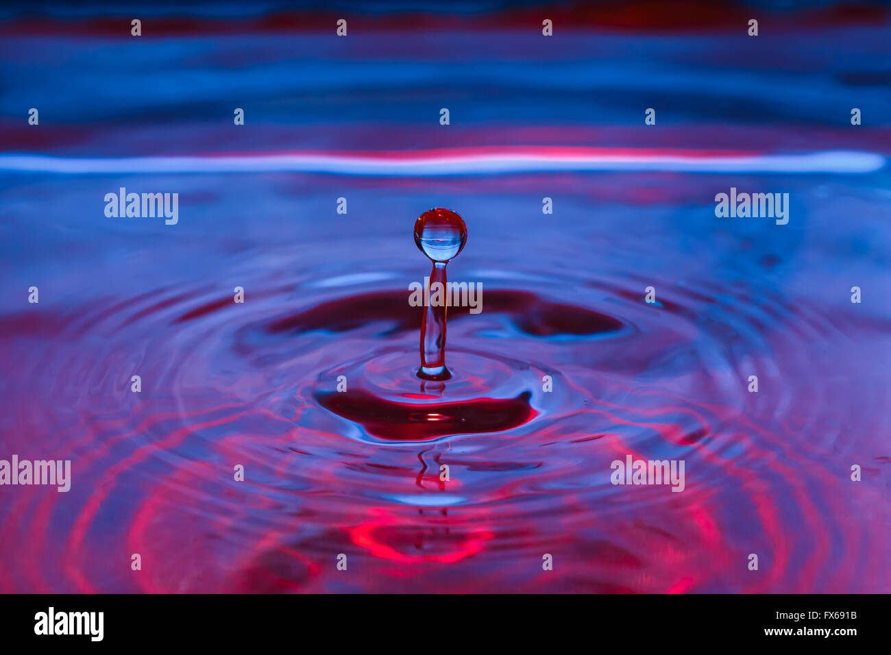 Beautiful colorful water splash from fallen drop Stock Photo - Alamy