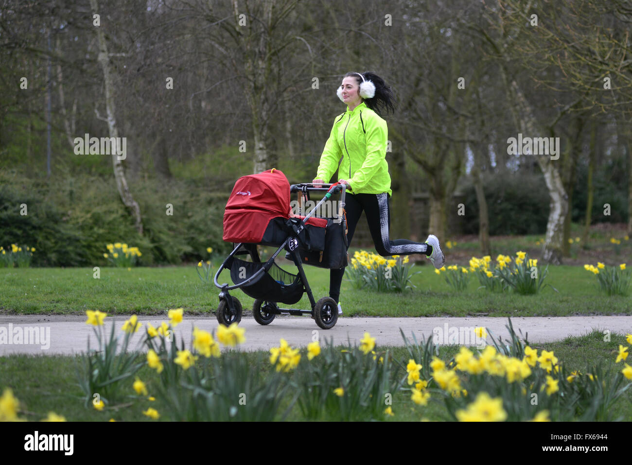 A mum running with her child in a buggy Stock Photo - Alamy