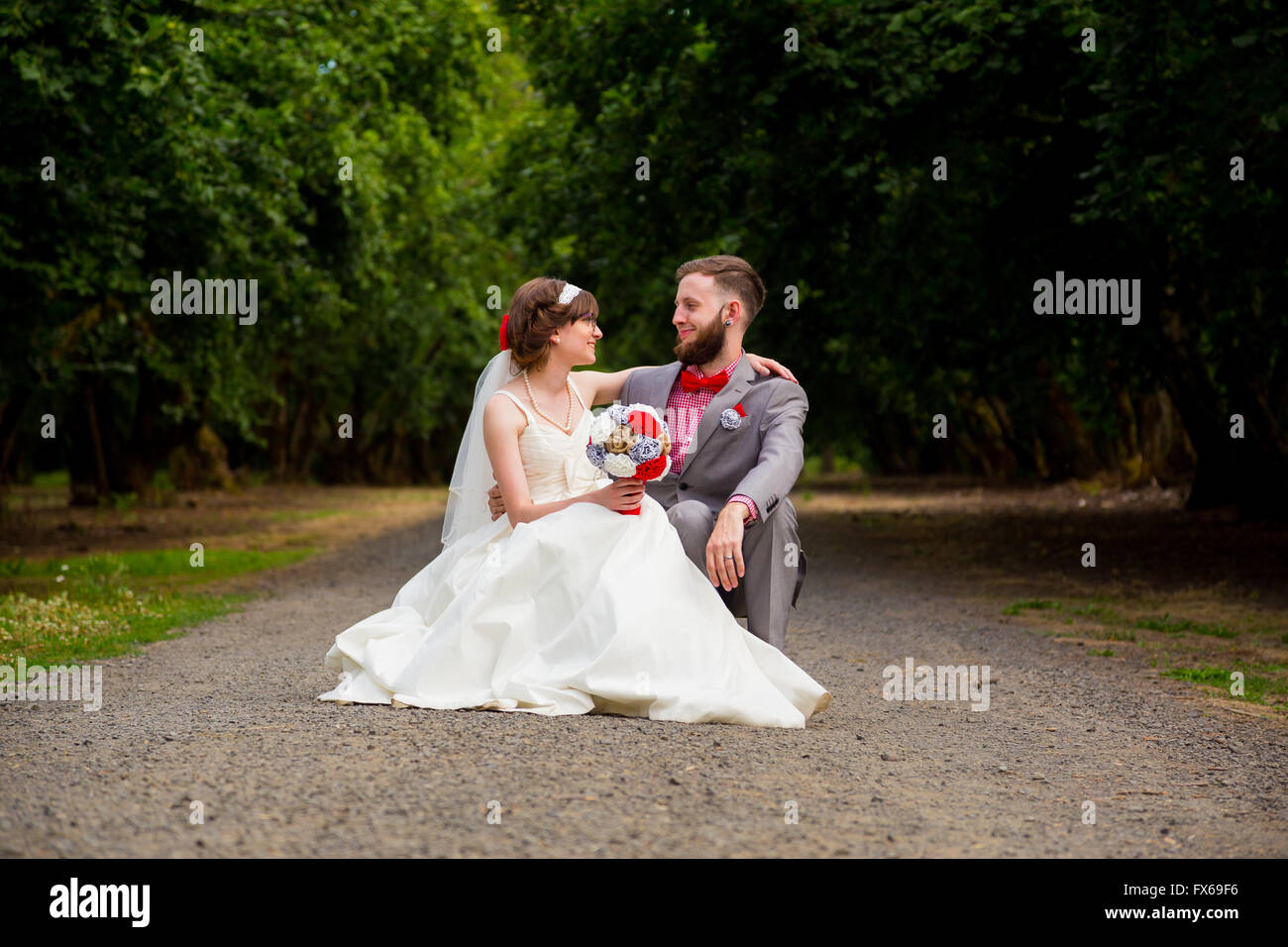 Bride and groom sharing a moment after their wedding ceremony sitting ...