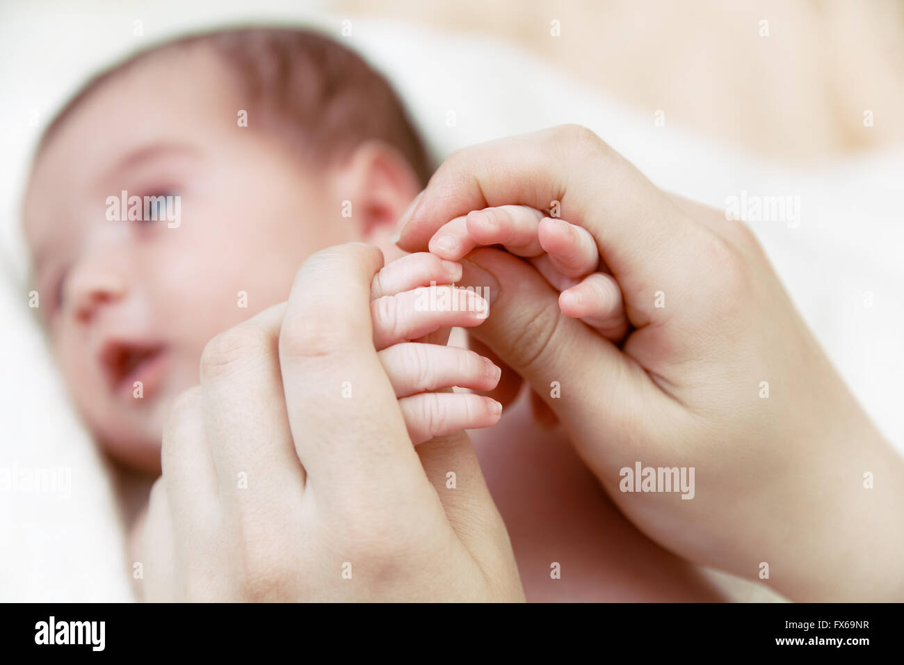 Little palms of newborn baby in mother's hands Stock Photo - Alamy