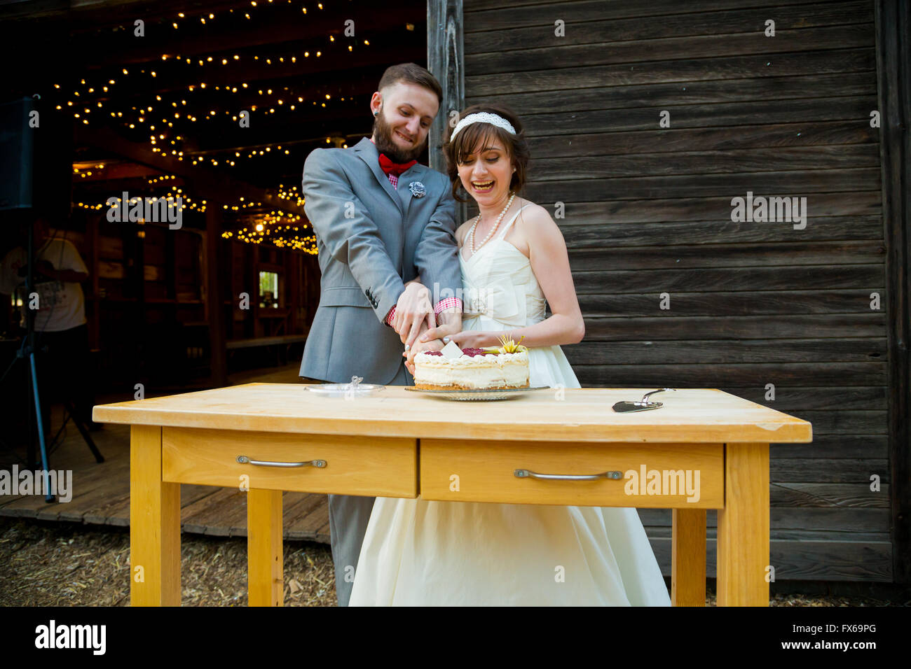 Bride and groom cut the cake and feed each other on their wedding day ...