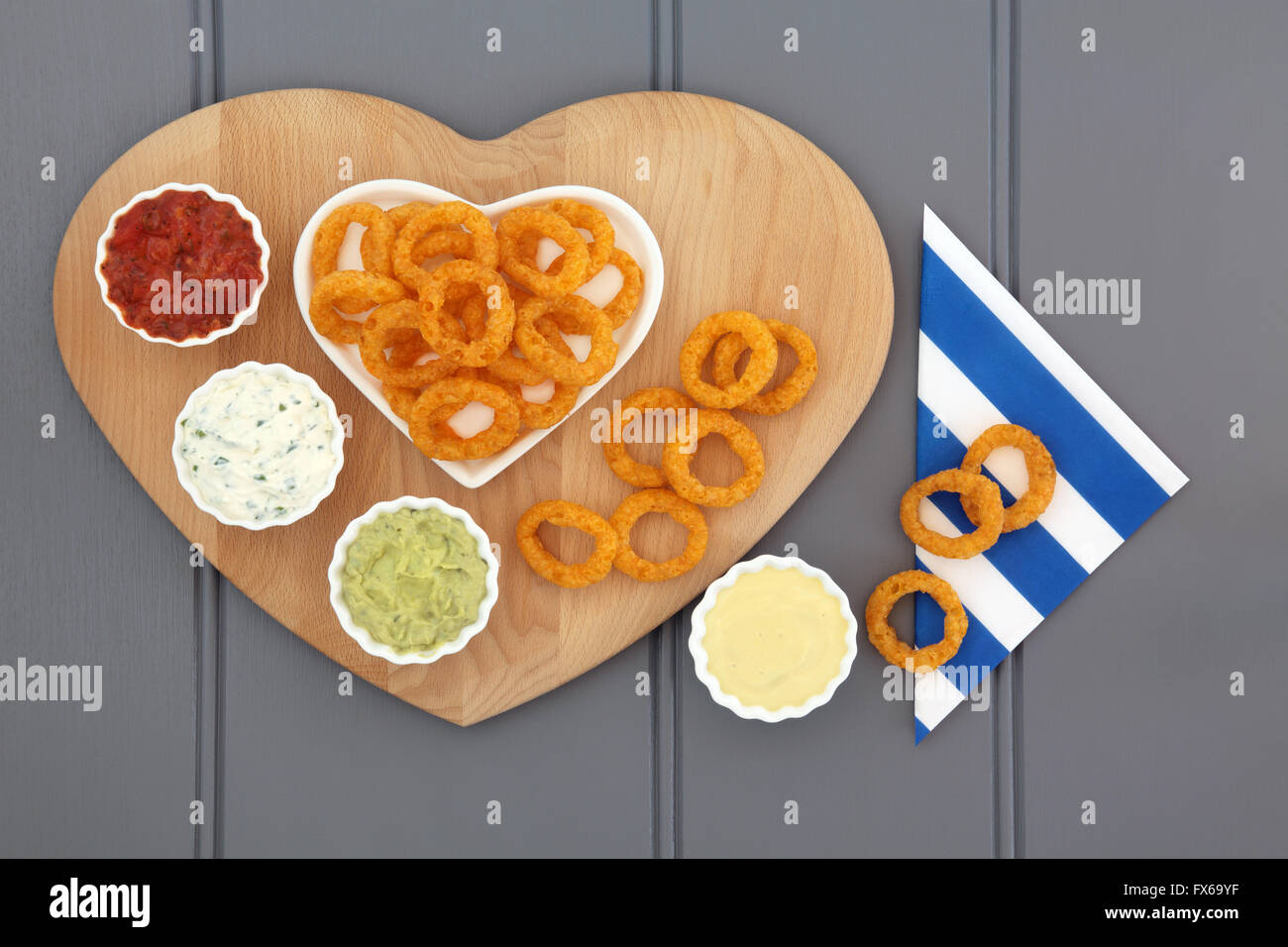 Onion ring snack food with dip selection and striped napkin Stock Photo ...