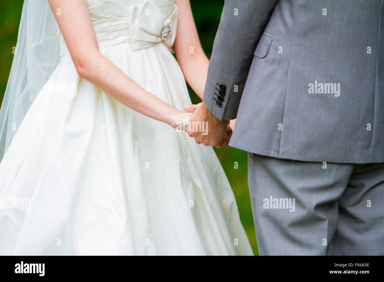 During the wedding ceremony a bride and groom hold hands together Stock ...