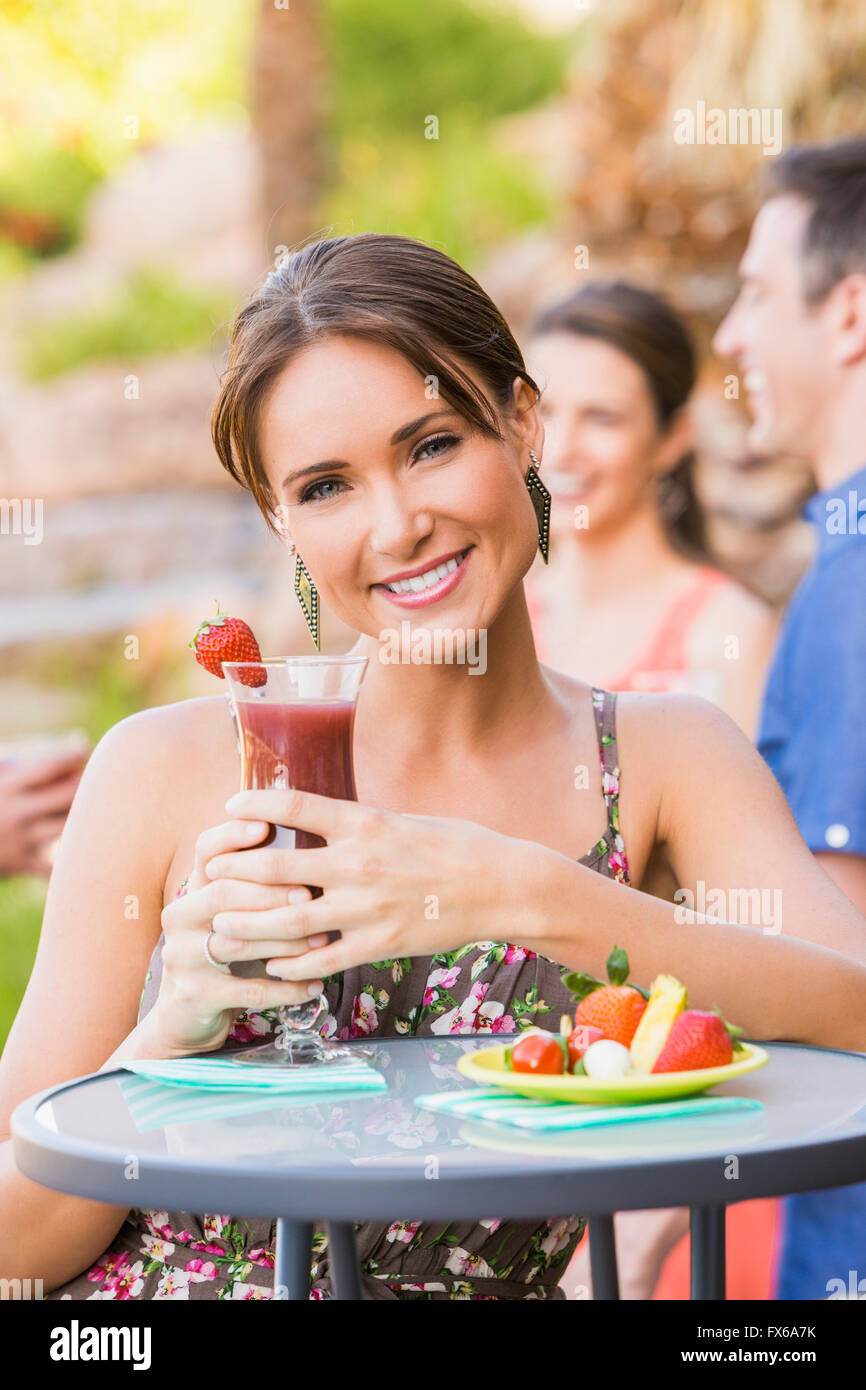 Woman drinking cocktail outdoors Stock Photo - Alamy