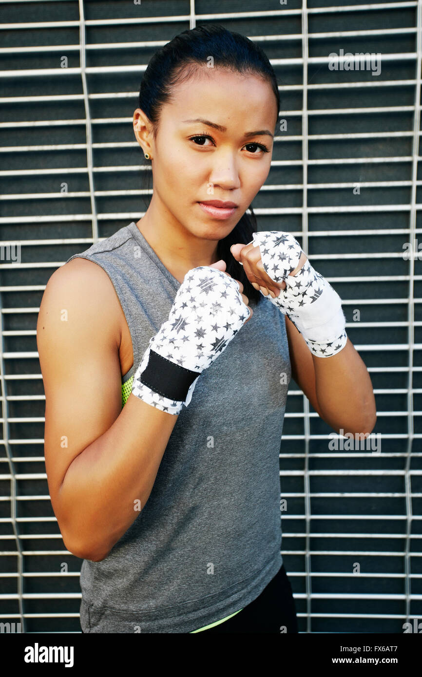 Mixed race athlete with raised fists Stock Photo - Alamy