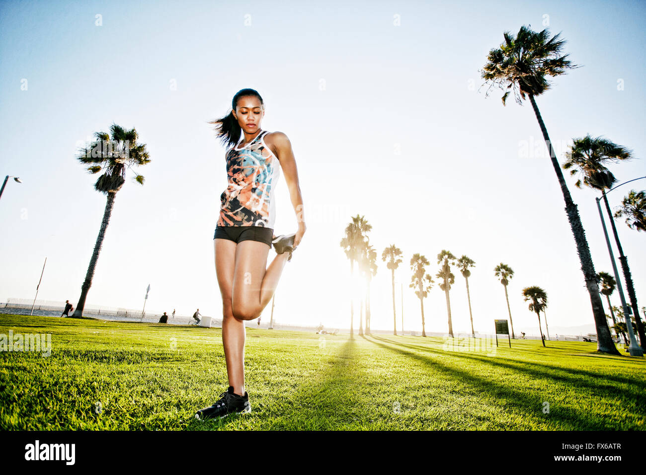 Mixed race athlete stretching in park Stock Photo - Alamy