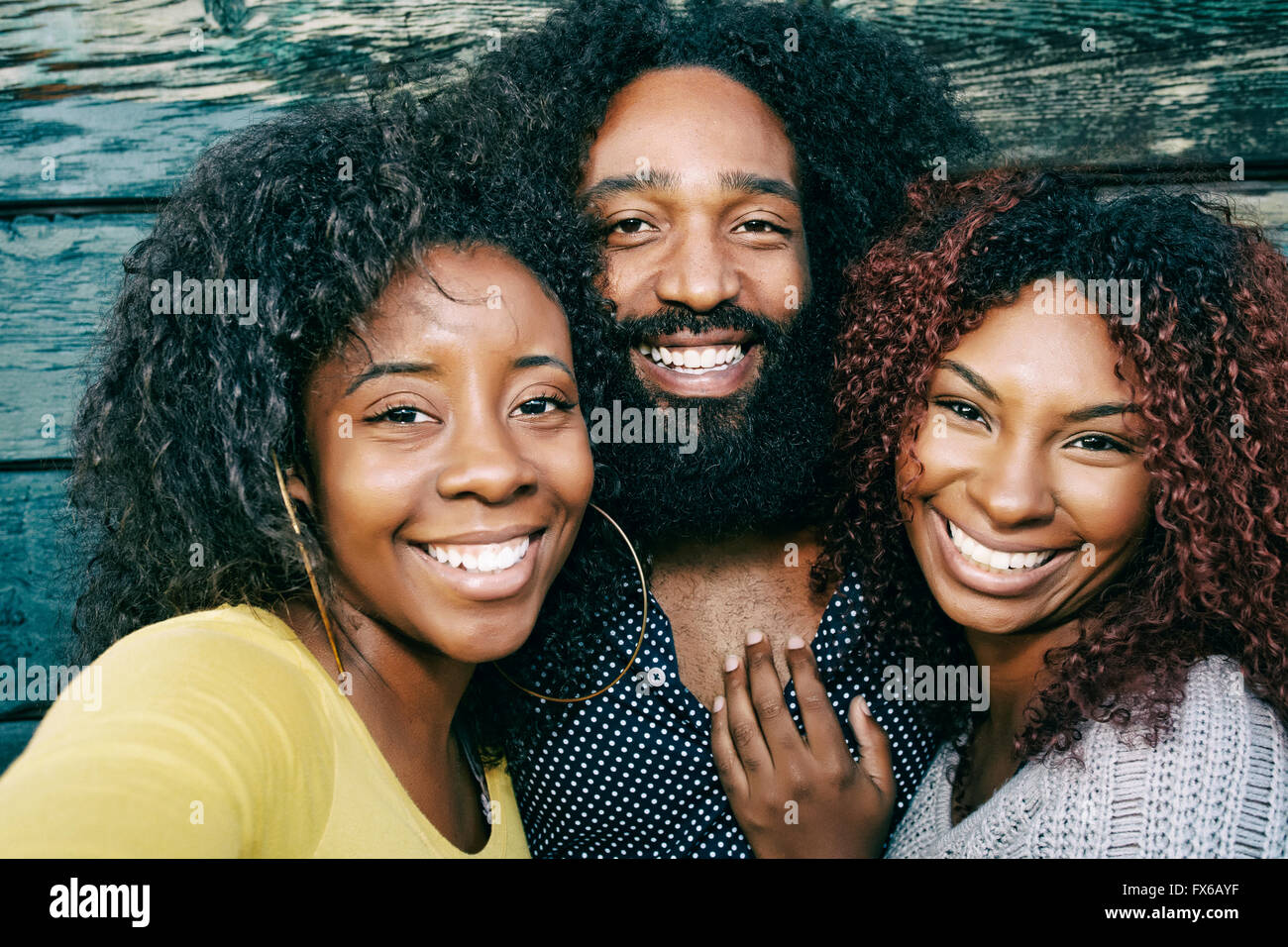 Friends smiling outdoors Stock Photo - Alamy