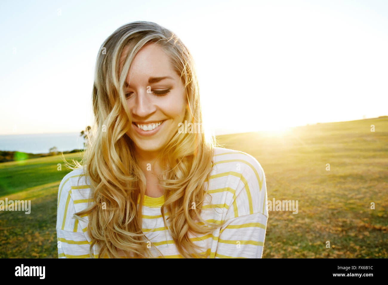 Caucasian woman smiling in field Stock Photo - Alamy