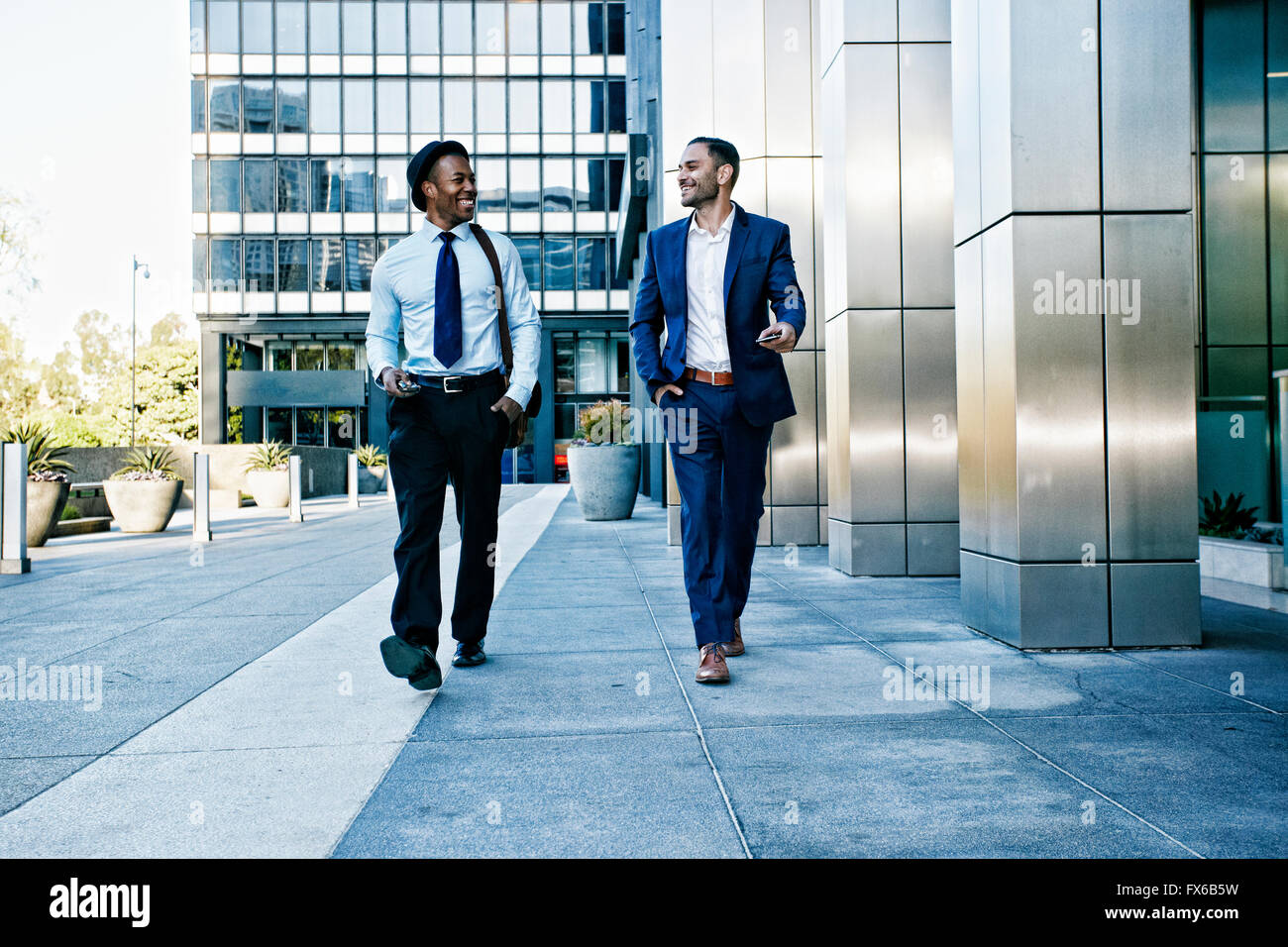 Businessmen talking outside office building Stock Photo - Alamy