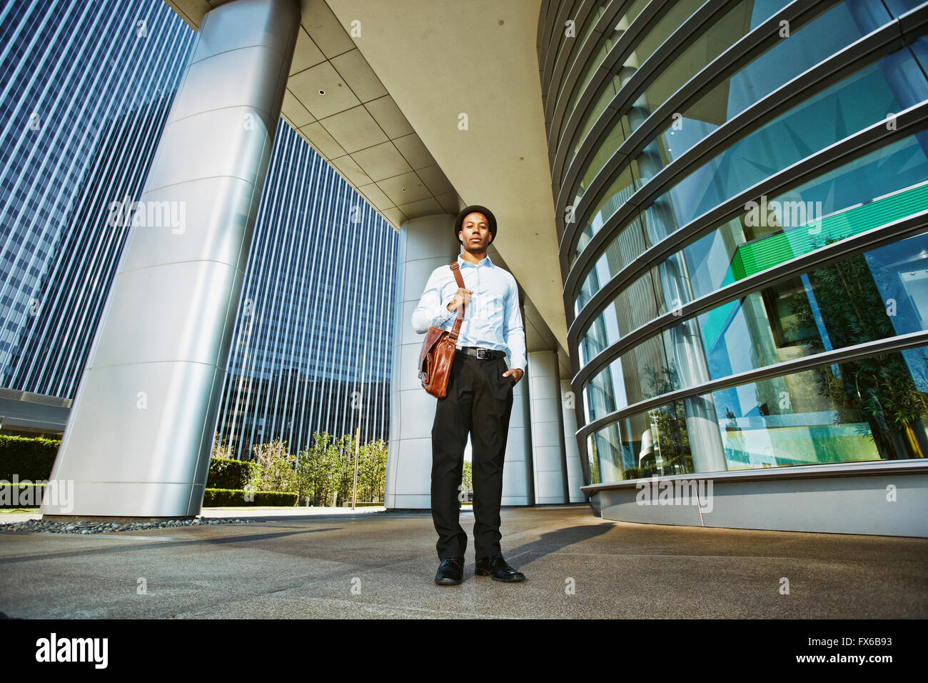 Young men standing in front of building hi-res stock photography and ...