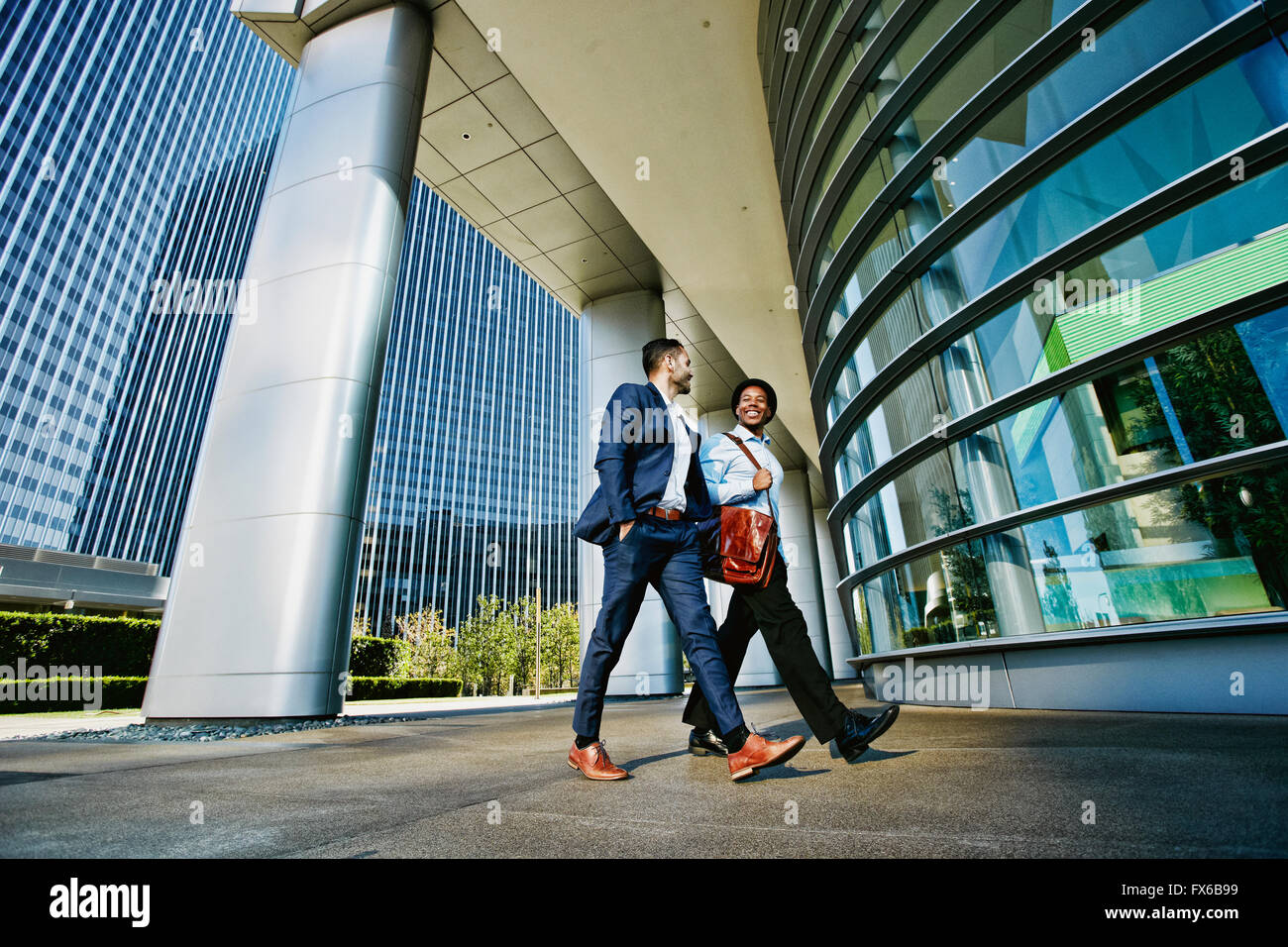 Businessmen walking outside office building Stock Photo - Alamy