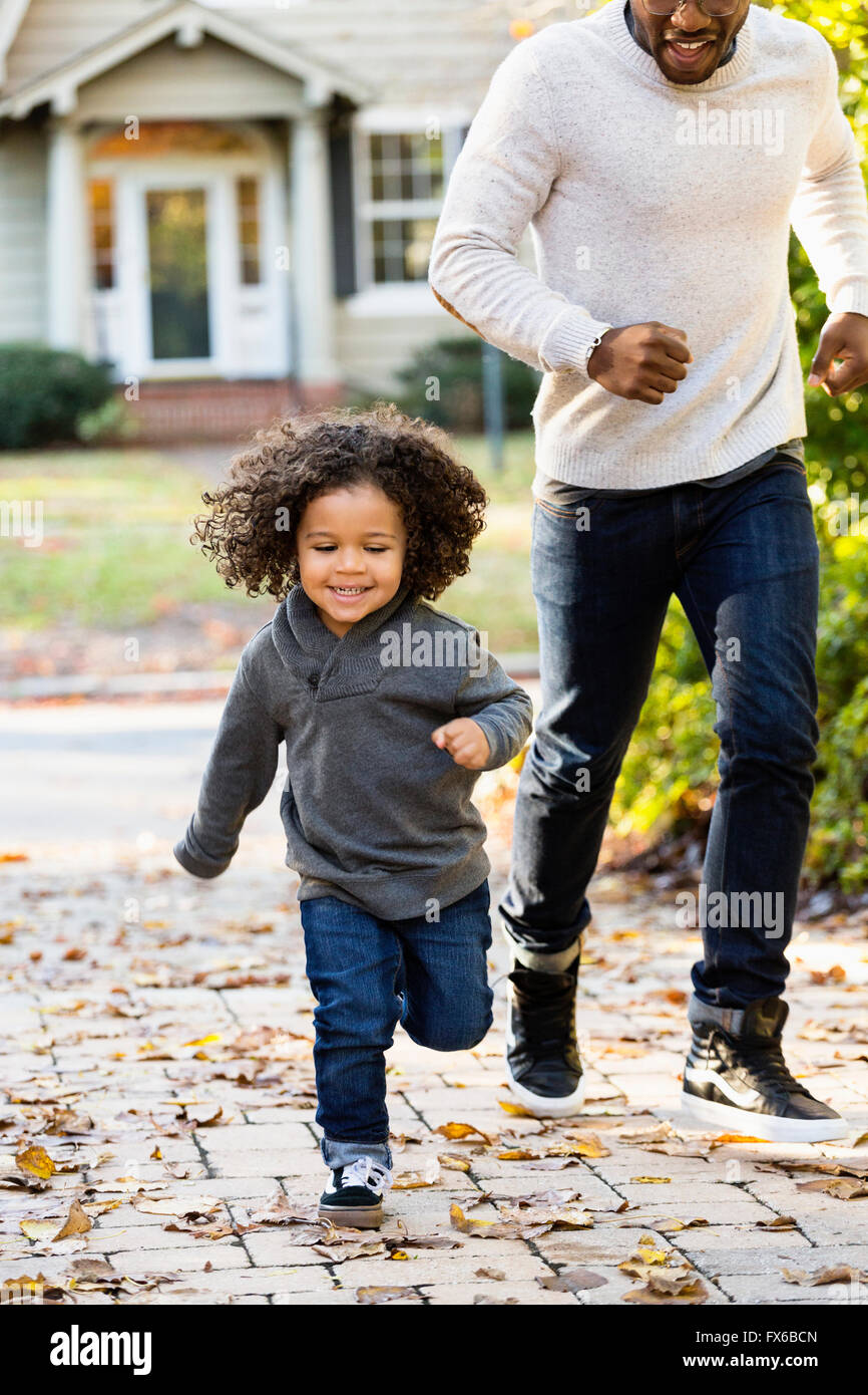 Father and son playing in driveway Stock Photo - Alamy