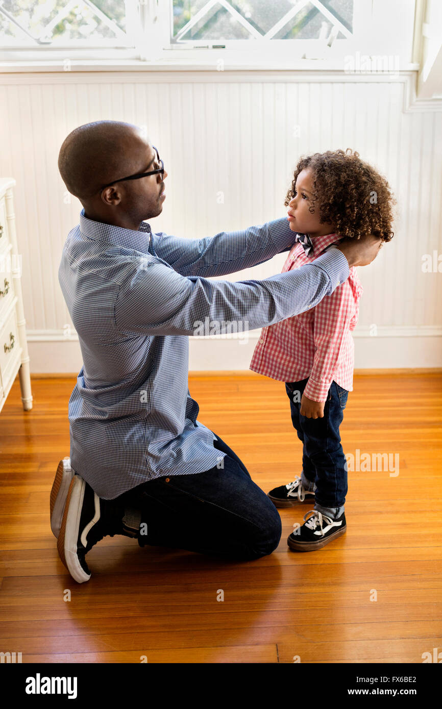 Father adjusting collar for son Stock Photo - Alamy