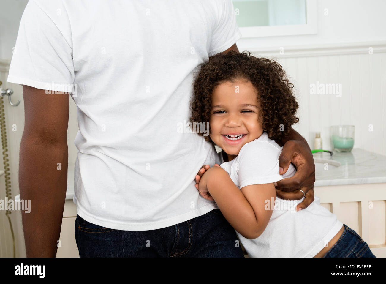 Father and son hugging in bathroom Stock Photo - Alamy