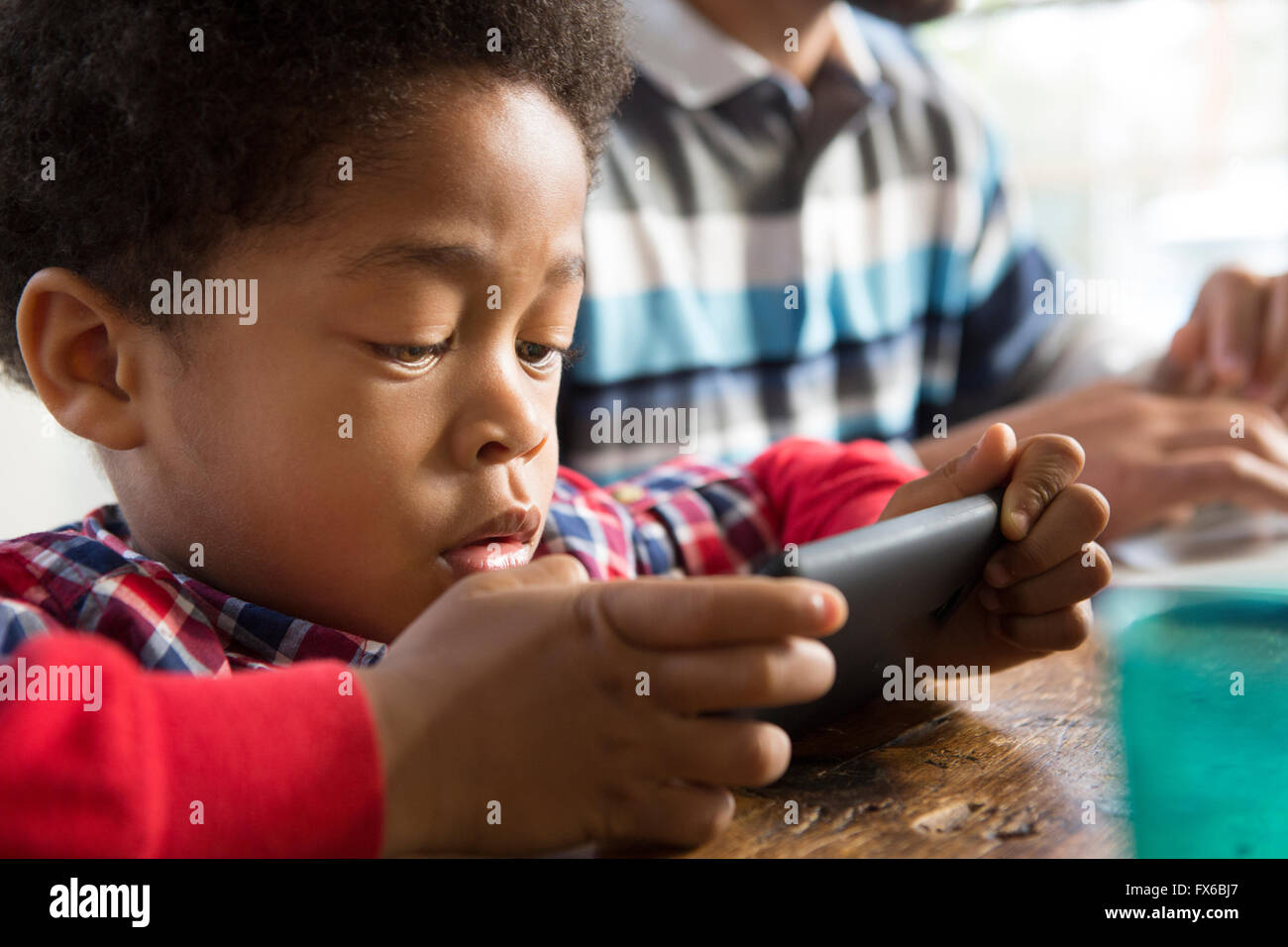 African american man boy using hi-res stock photography and images - Alamy