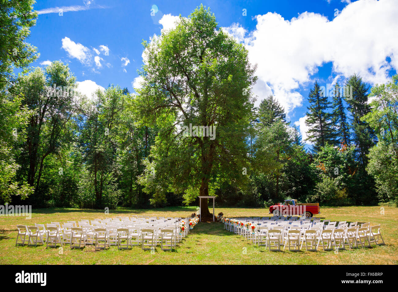 Wedding ceremony location with chairs set up for guest seating on a ...