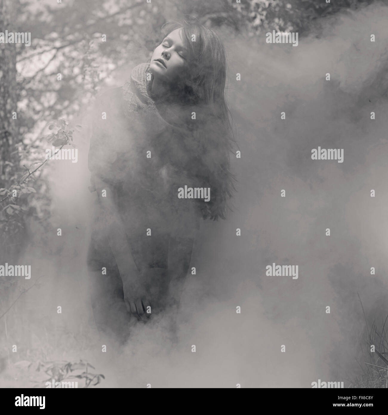 Caucasian woman standing in mist Stock Photo - Alamy