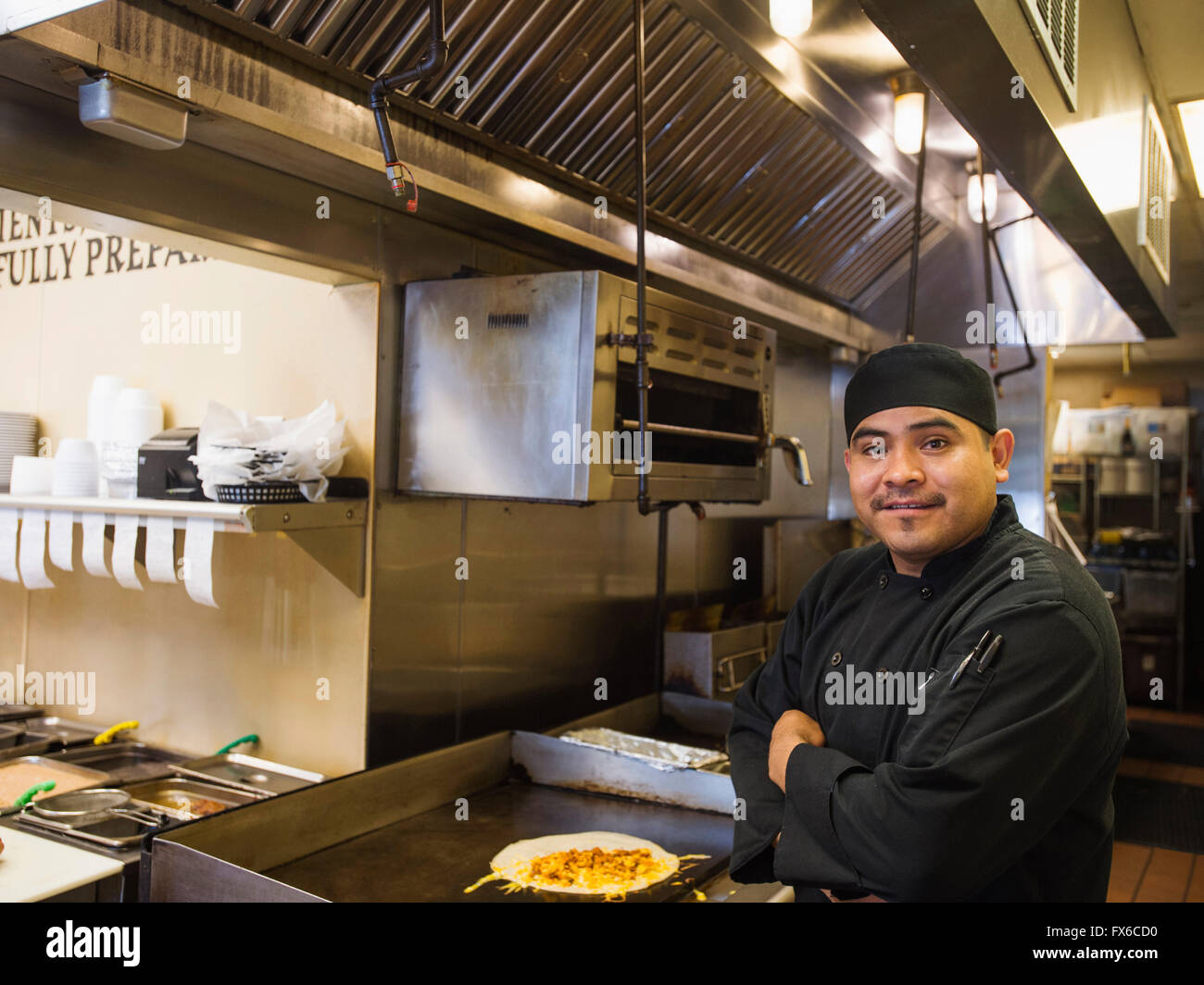 Hispanic chef smiling in kitchen Stock Photo - Alamy