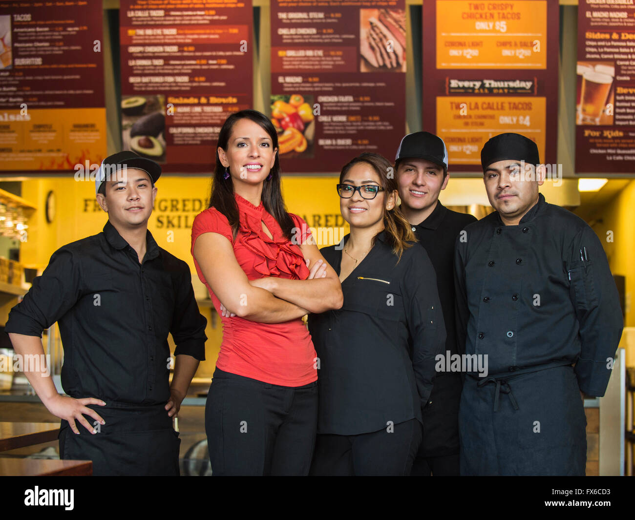 Hispanic business owner and employees smiling in cafe Stock Photo - Alamy