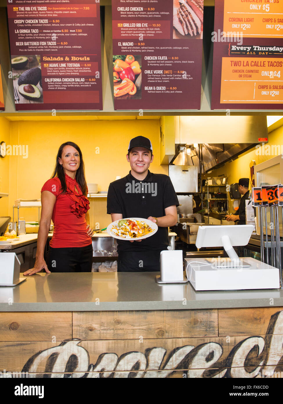 Hispanic server and businesswoman smiling in cafe Stock Photo - Alamy