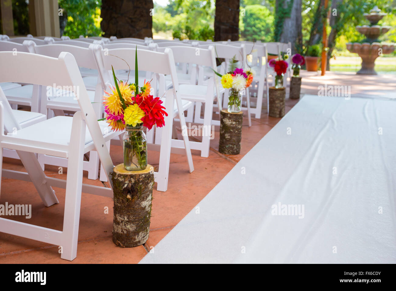 White chairs and rows of seating create a nice venue for the bride to ...
