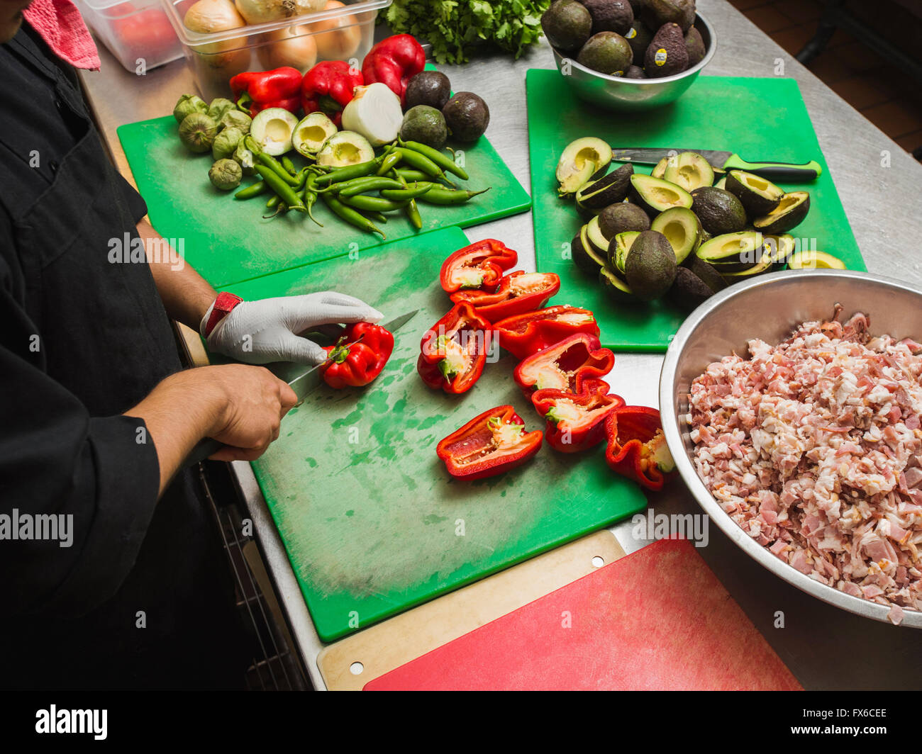 Hispanic chef cutting vegetables in kitchen Stock Photo - Alamy