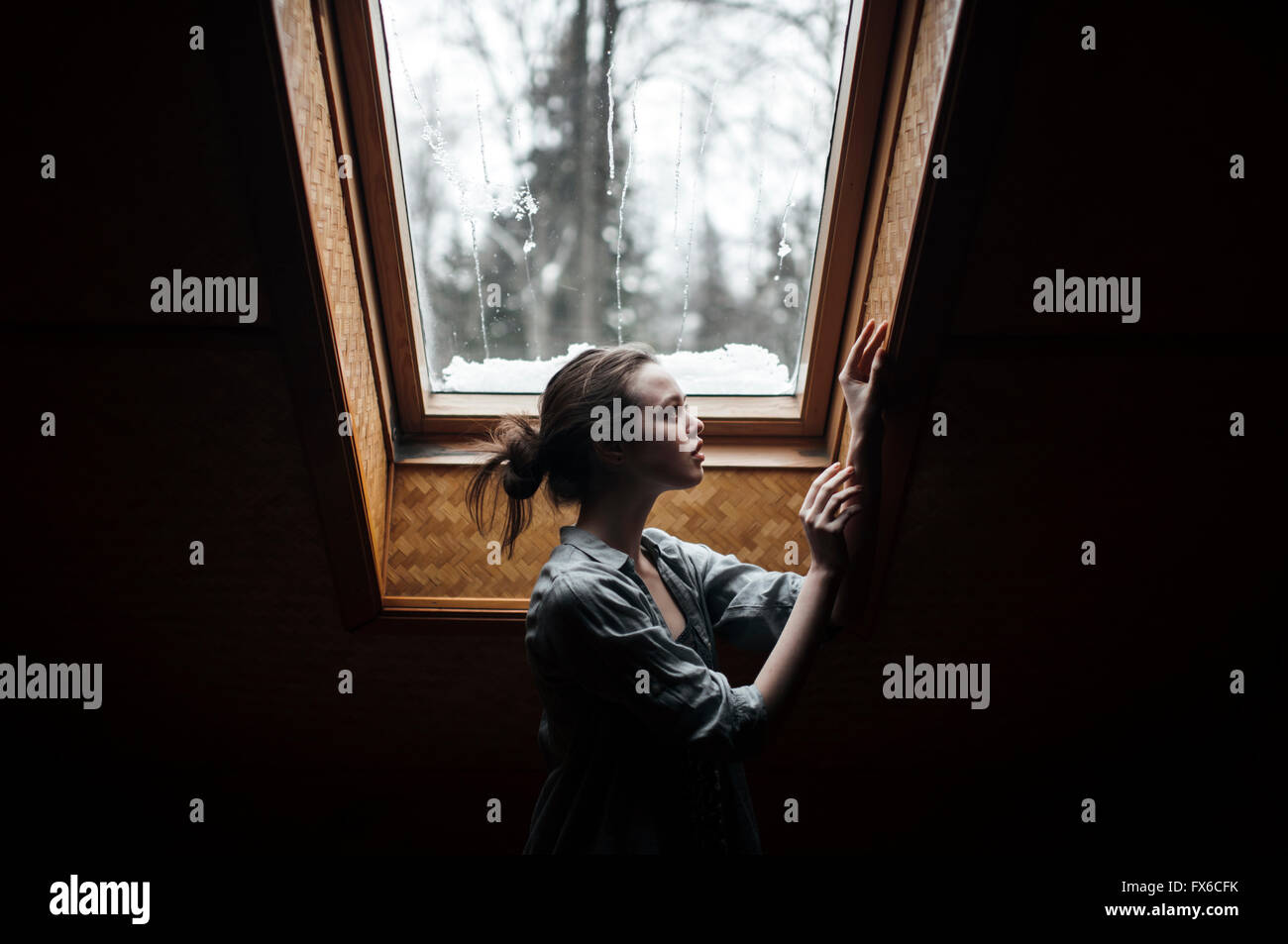 Caucasian woman standing under skylight Stock Photo - Alamy