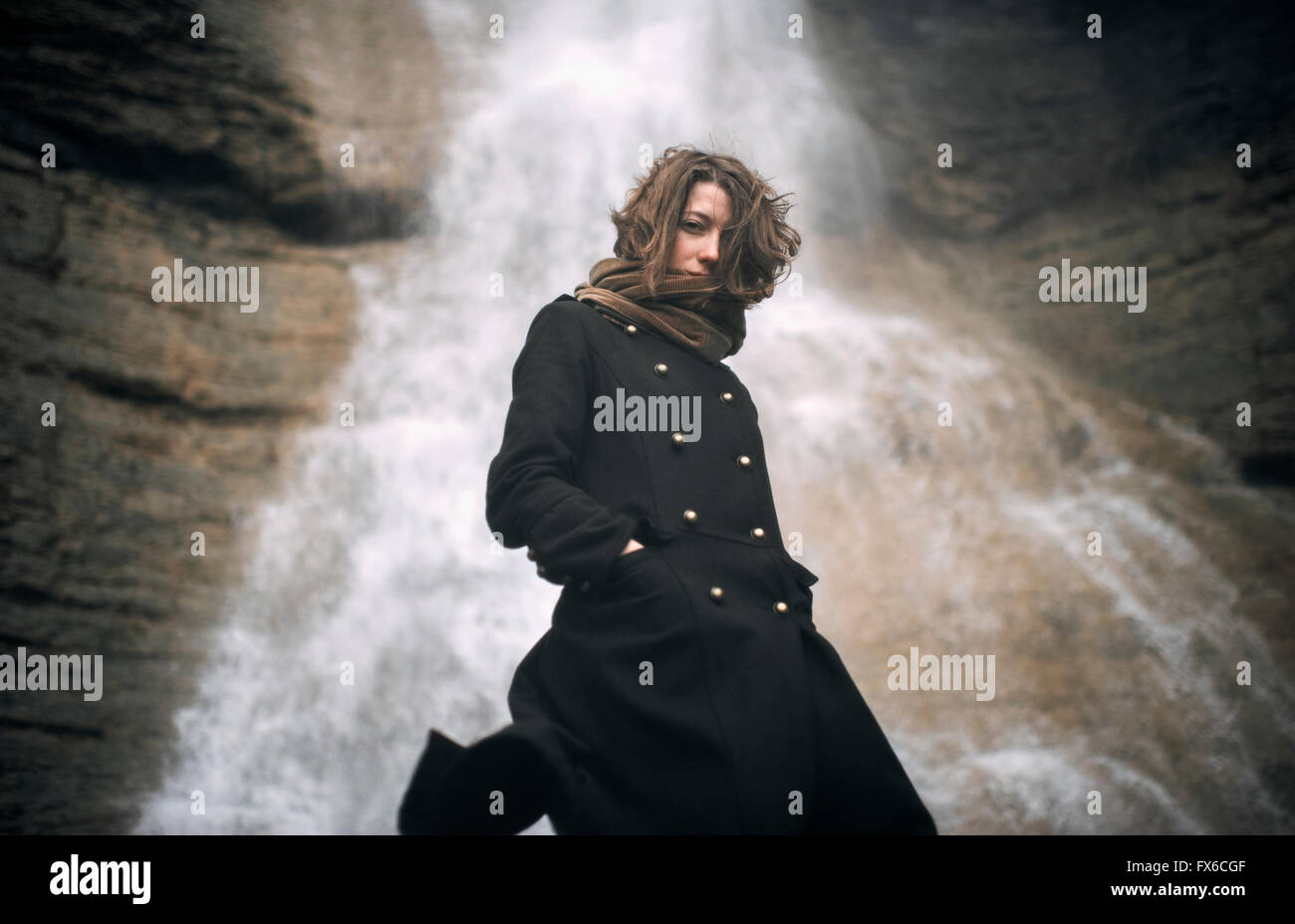 Caucasian woman standing under waterfall Stock Photo - Alamy