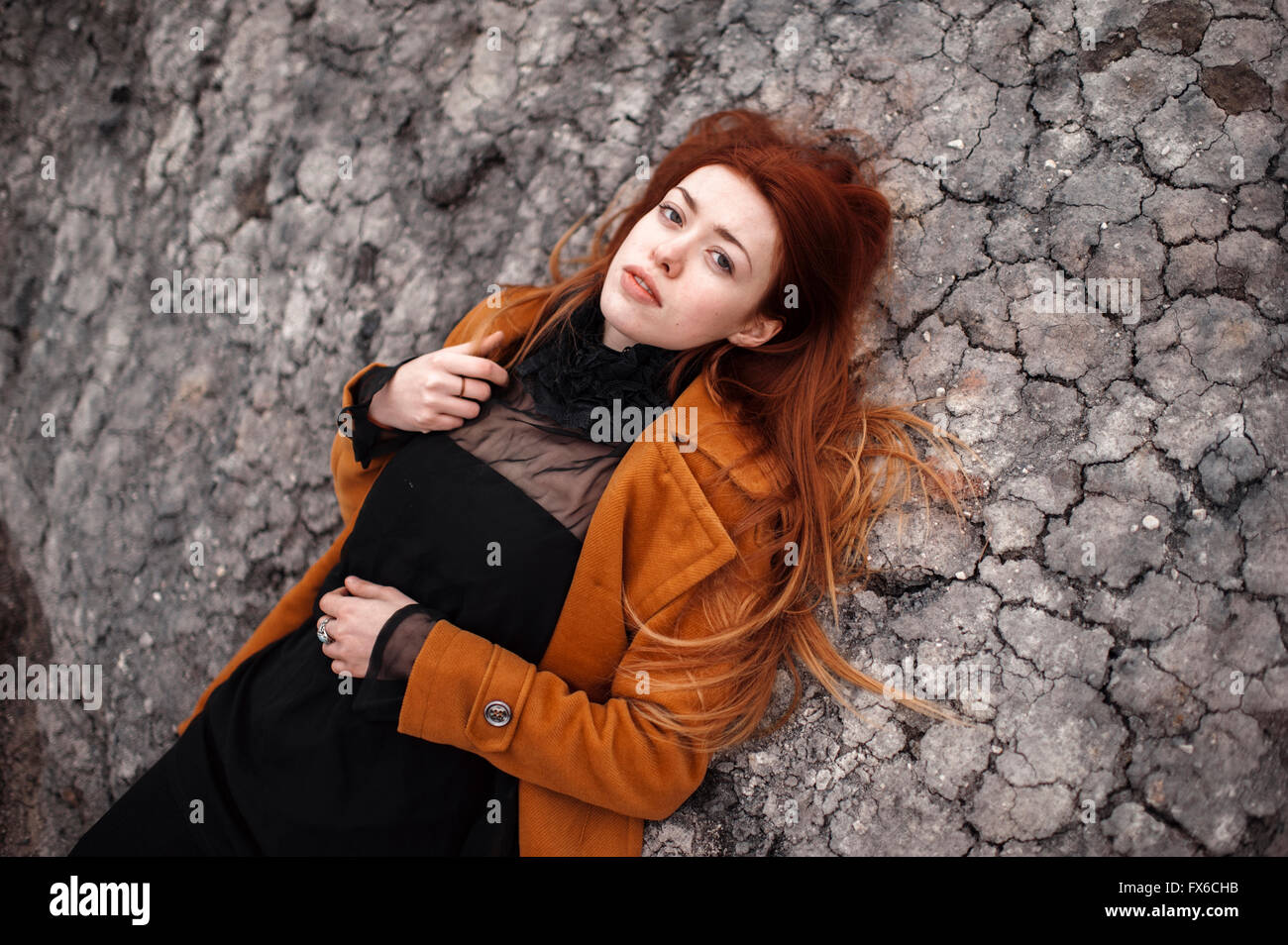 Caucasian woman laying on rock formation Stock Photo - Alamy