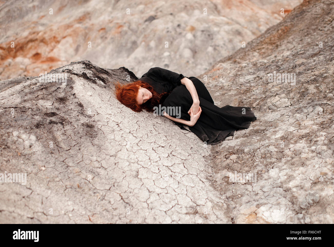 Caucasian woman laying on rock formation Stock Photo - Alamy