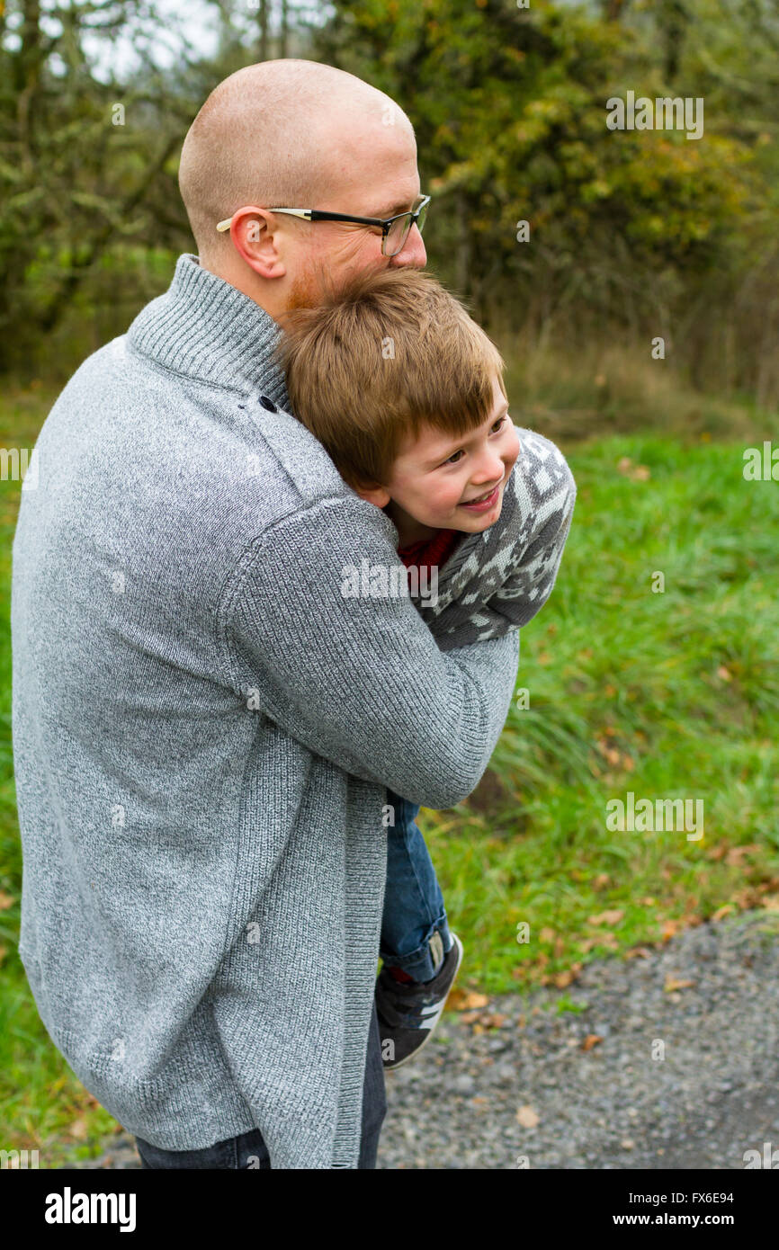 Dad and his son together in a lifestyle family portrait outdoors in the ...