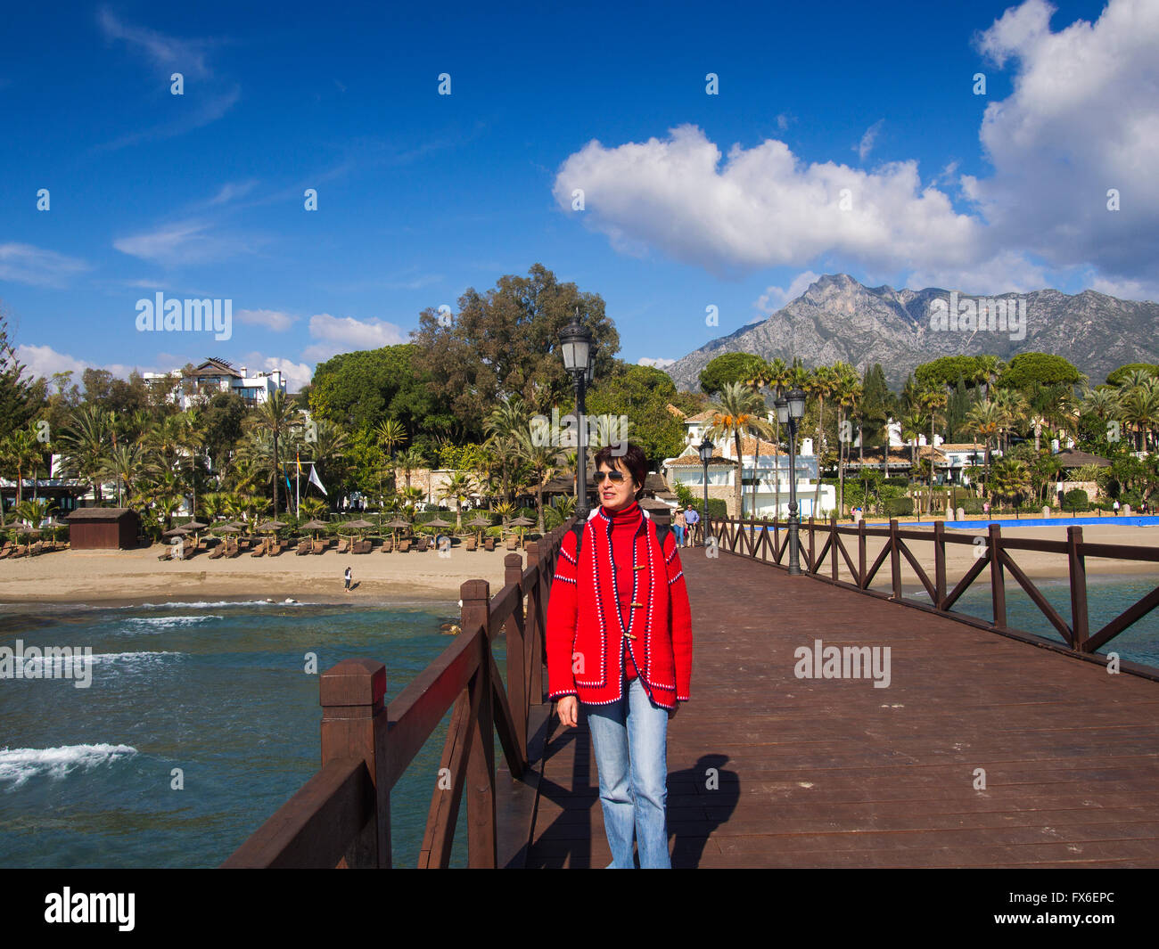 Woman. Wooden pier at Marbella Club Hotel, Marbella. Malaga province ...