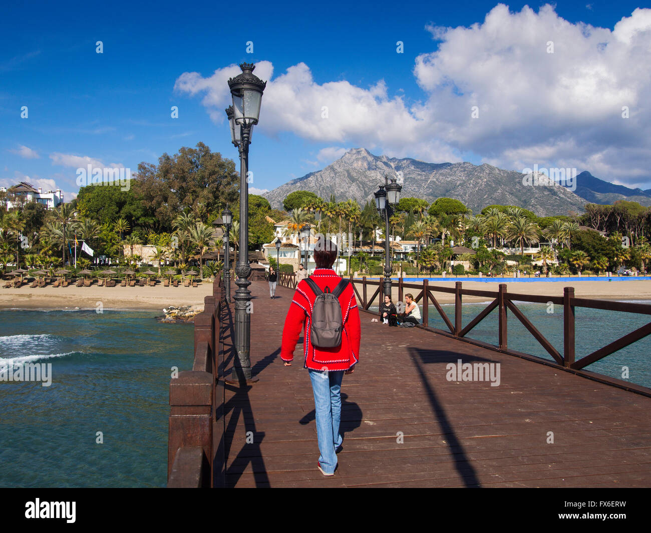 Woman. Wooden pier at Marbella Club Hotel, Marbella. Malaga province ...