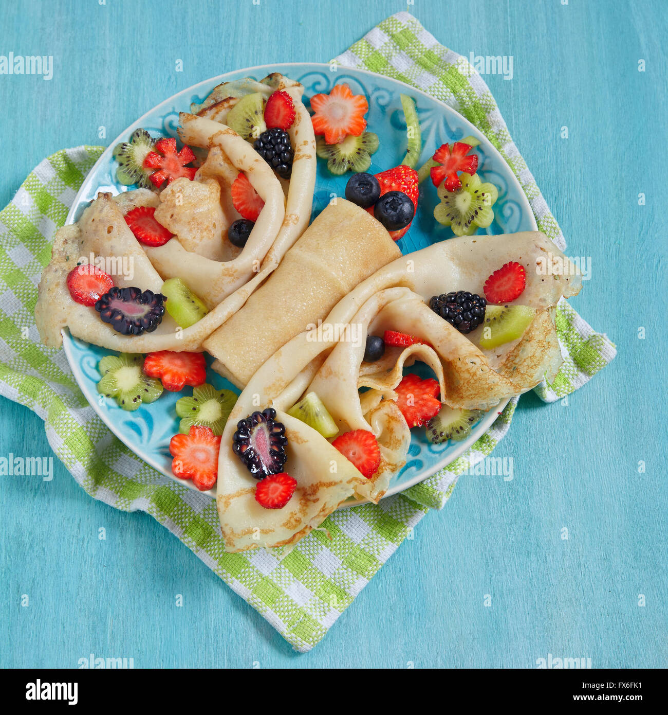 Funny butterfly shaped crepes with berries for kids Stock Photo - Alamy