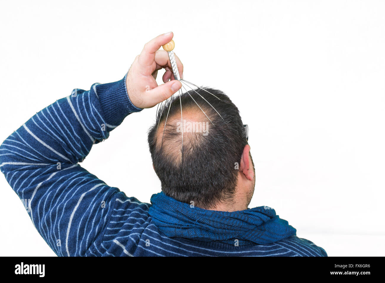 Man relaxes with the Genie head massager. Alternative Therapy. Indian ...