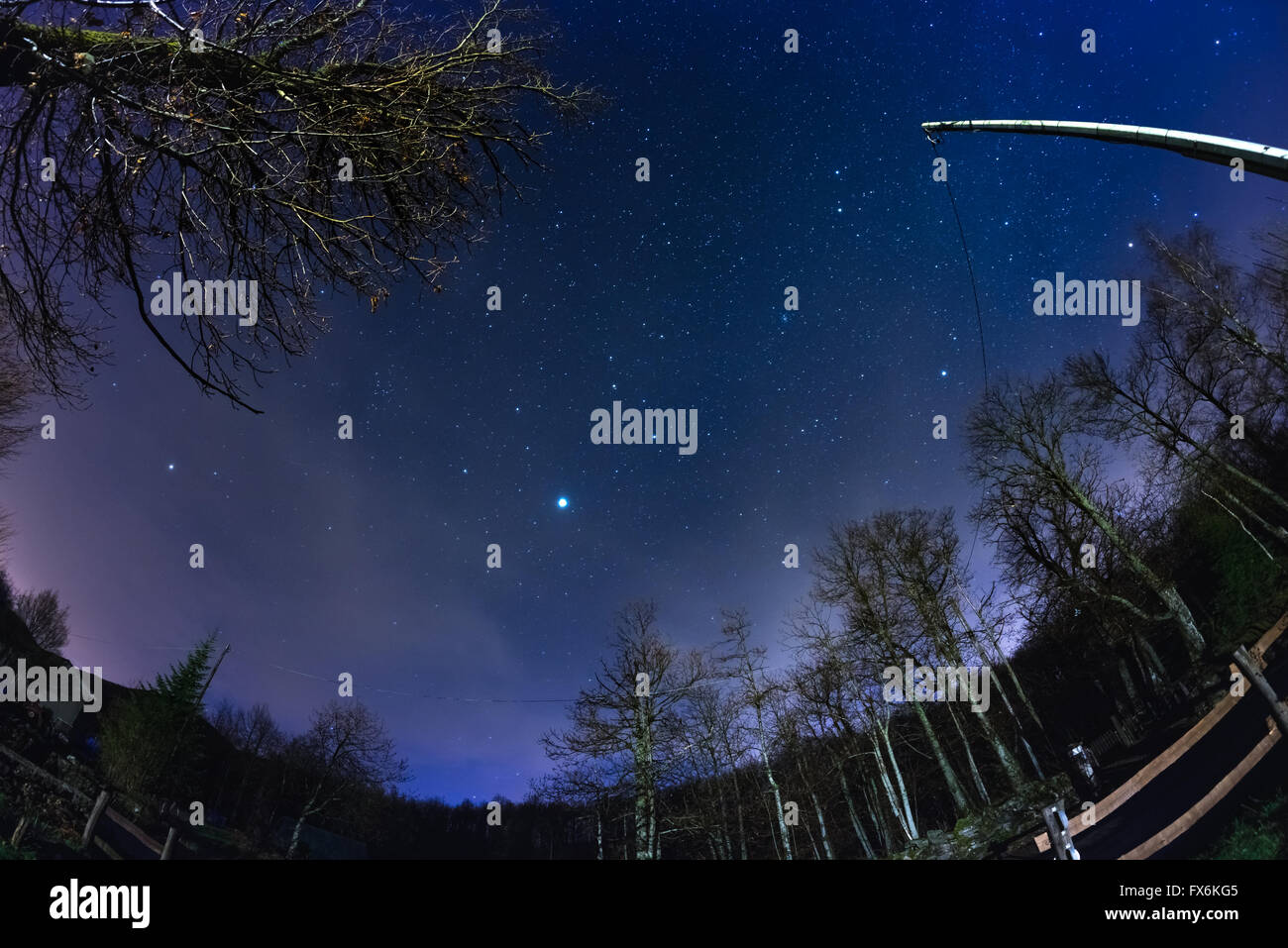 Fisheye view of the starry sky with blurred motion clouds, captured ...