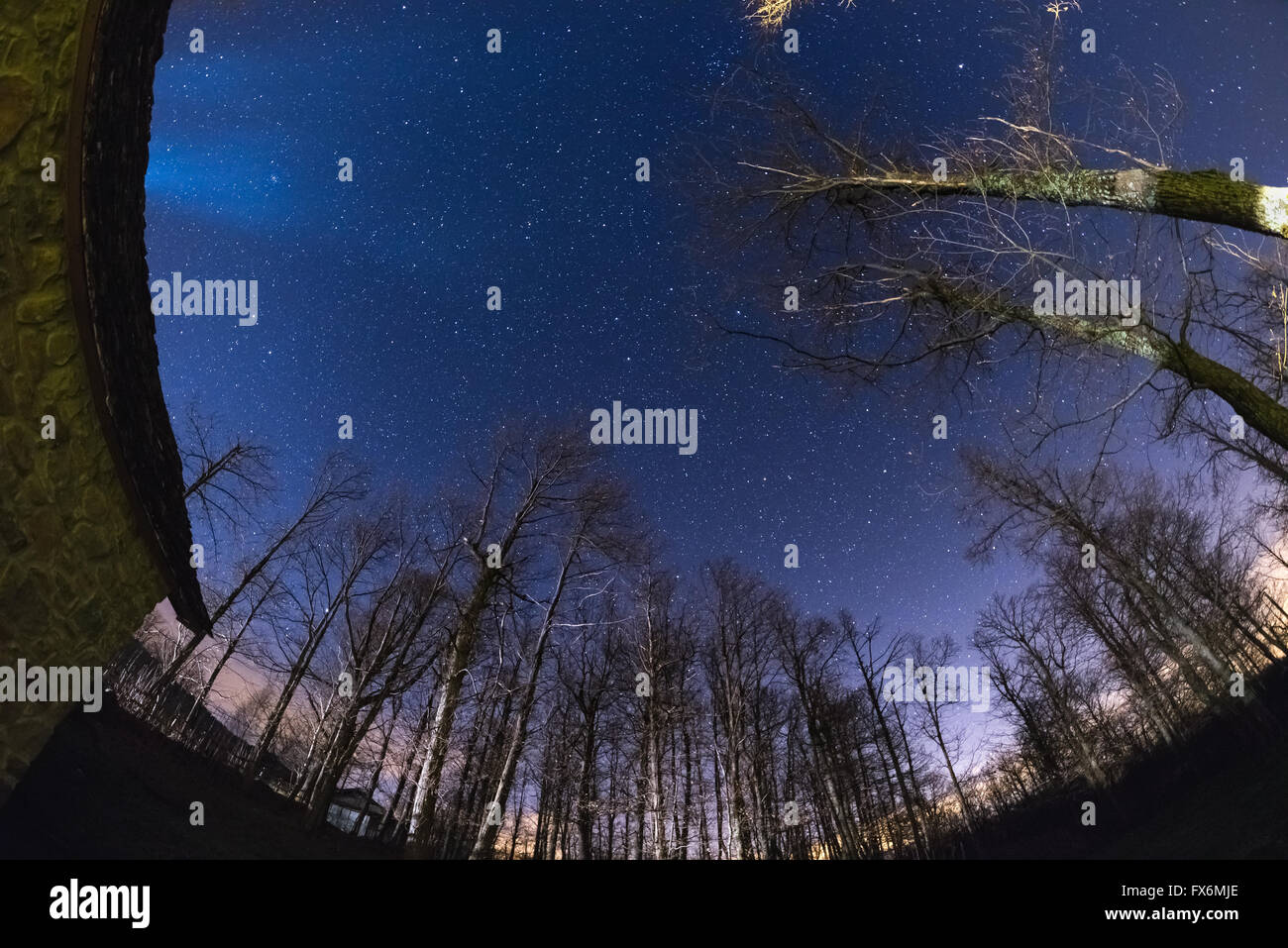 Fisheye view of the starry sky with blurred motion clouds, captured ...