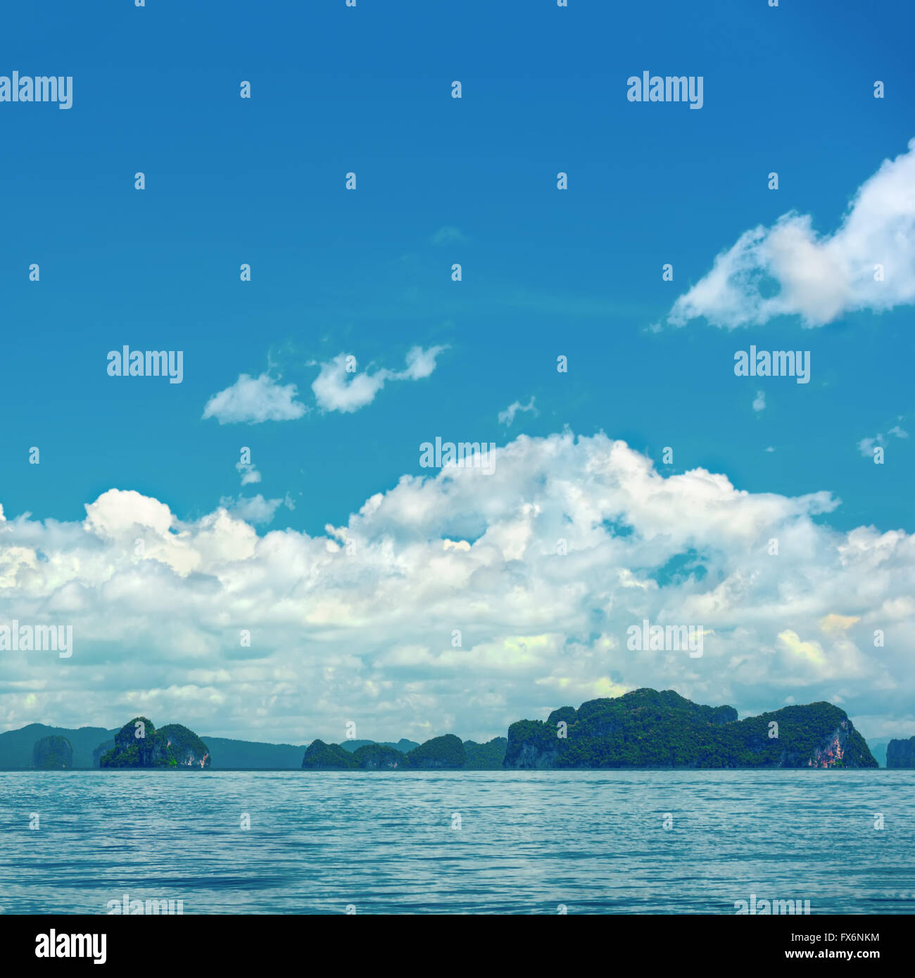 tropical blue ocean and clouds on sky with island, travel destination ...