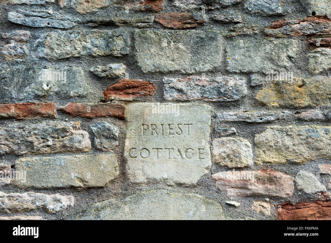 Priest Cottage sign carved in stone above a door. Wells, Somerset ...
