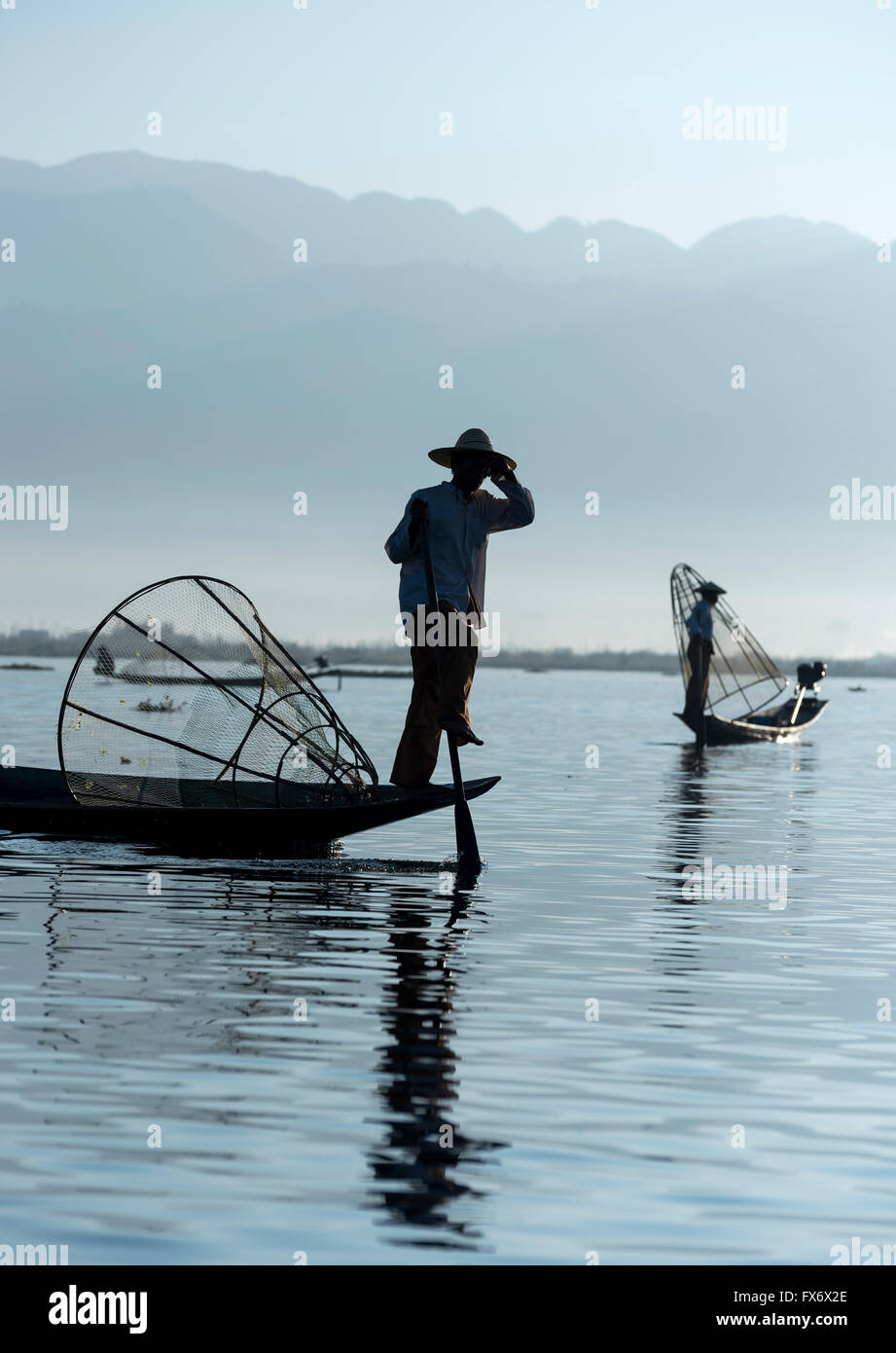 Intha leg-rowers with traditional conical fishing nets, Inle Lake ...