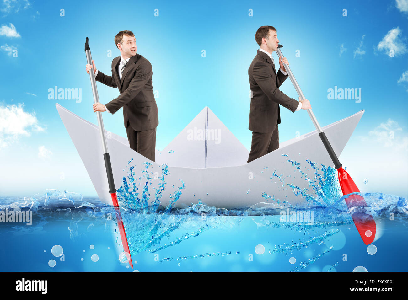 Two businessmen in paper boat Stock Photo - Alamy