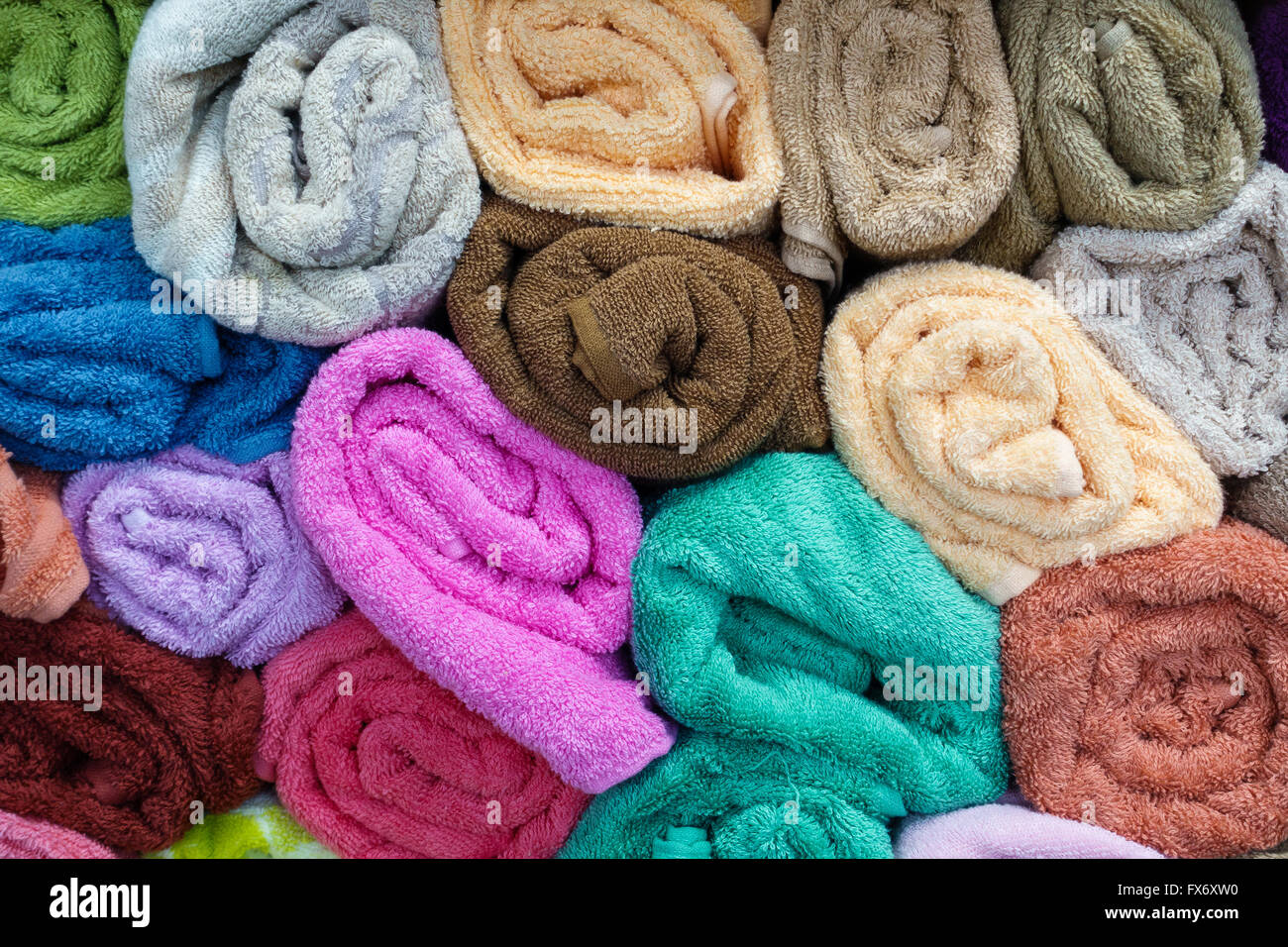 A stack of colorful rolled towels Stock Photo - Alamy